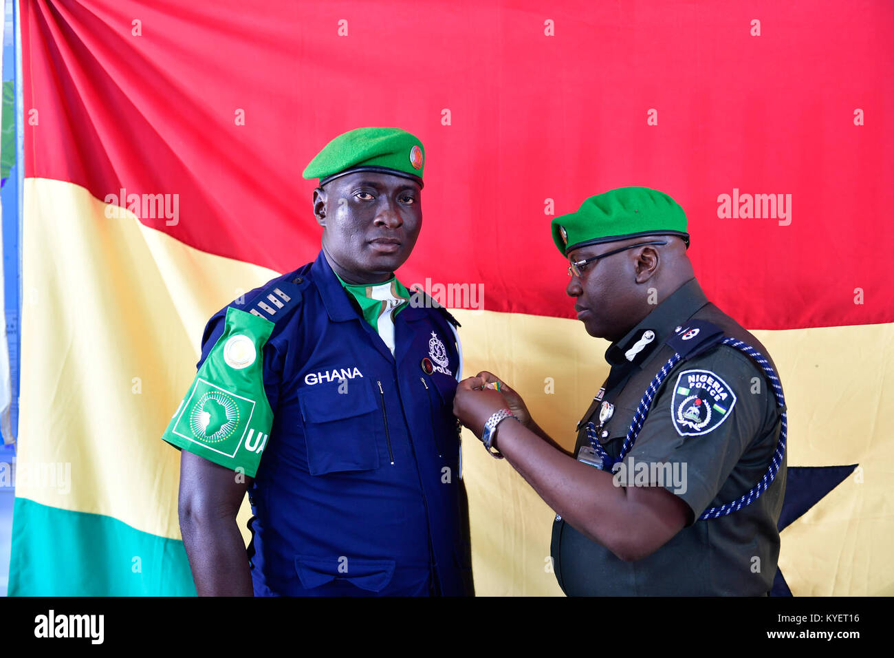 Rex Dundun, the AMISOM Police Chief of Staff, pins a medal on a ...