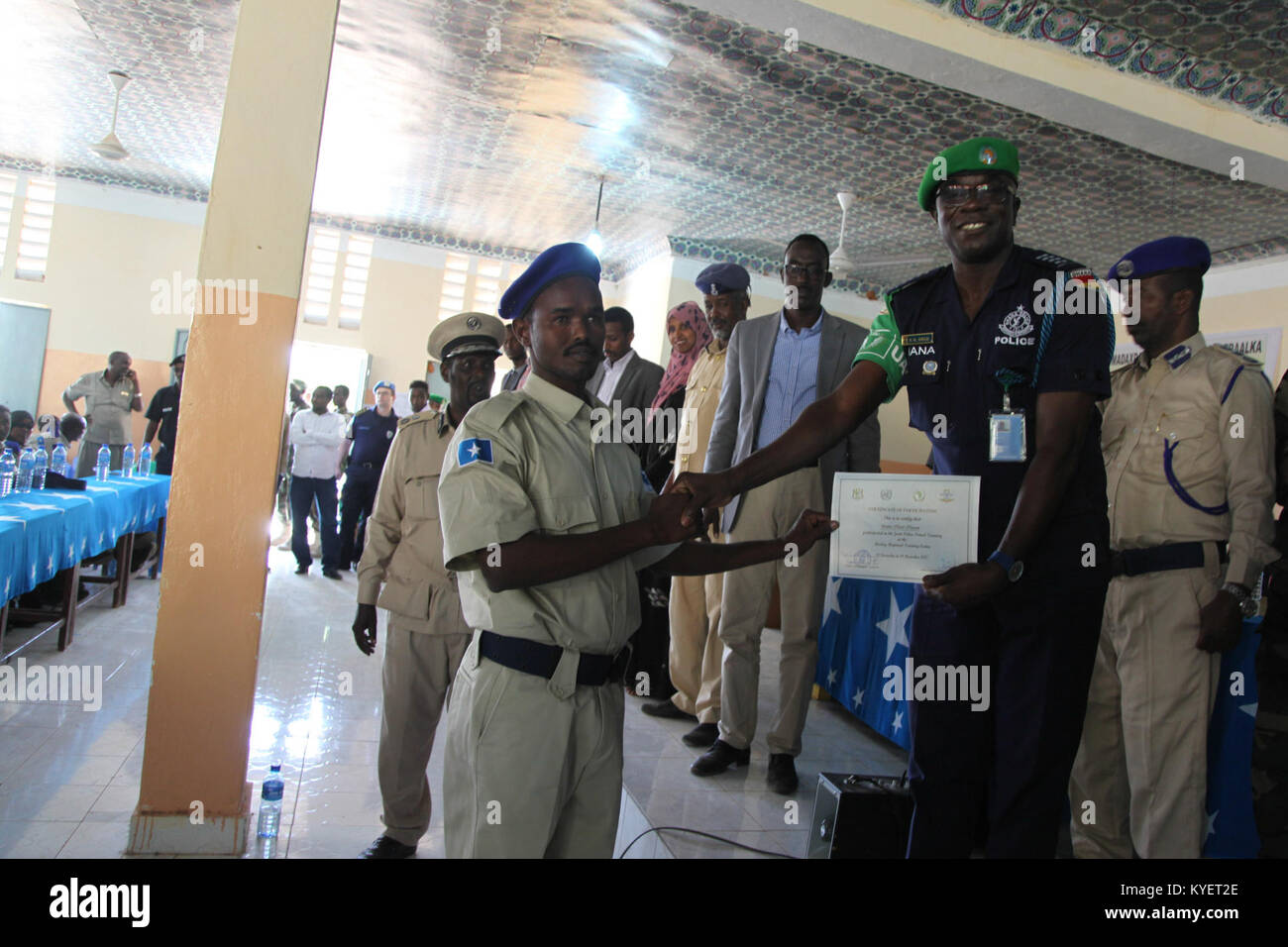 Chief Inspector Prosper Kofi Oklu of AMISOM hands over a certificate to ...