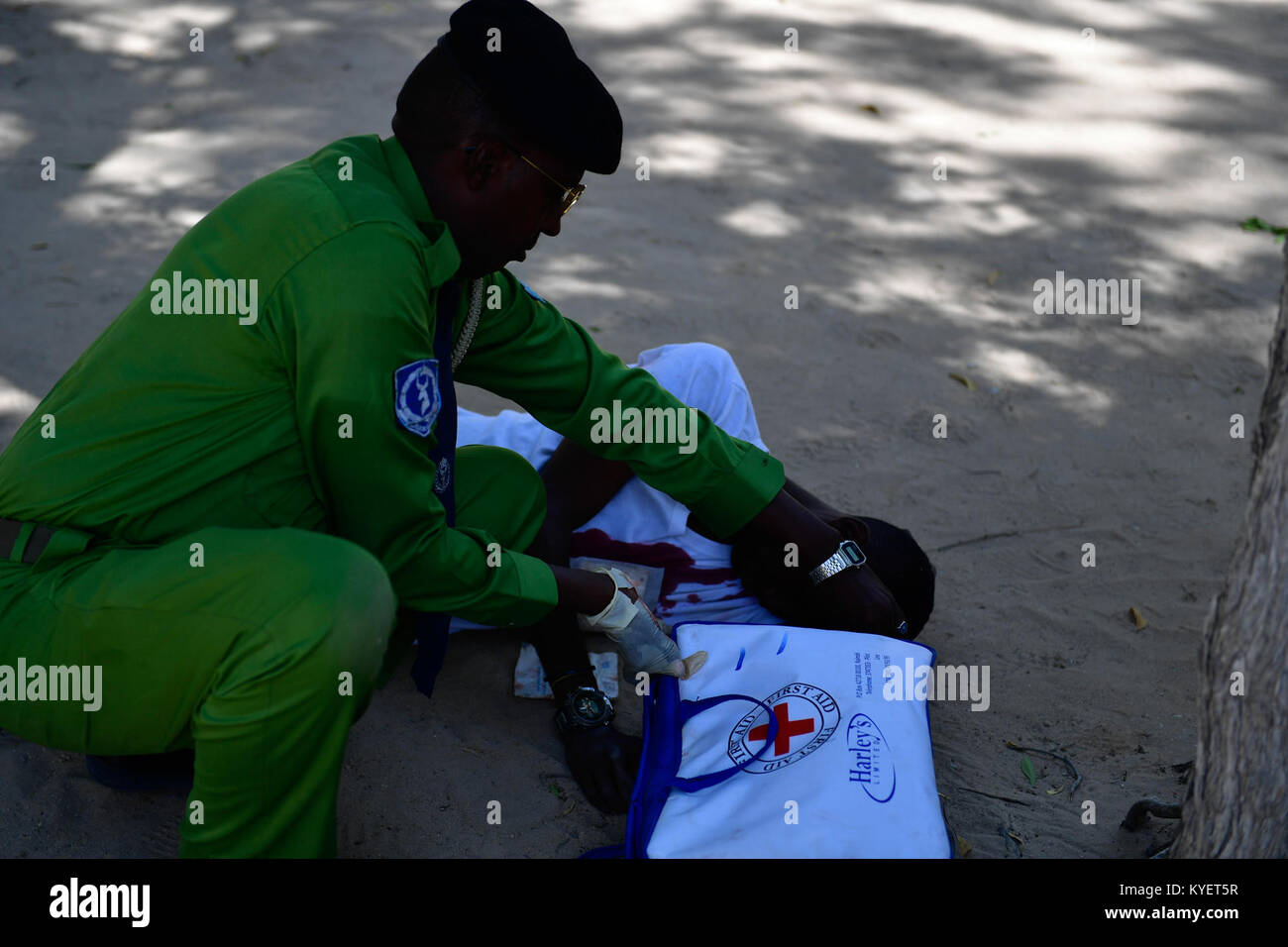 A Somali police officer treats a colleague during a demonstration of ...