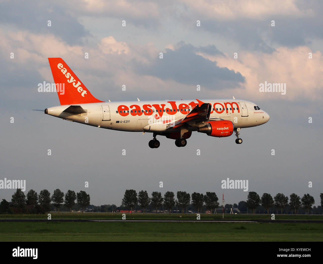 This image shows easyJet Airbus A319-111 (G-EZIY) landing on runway 18R ...