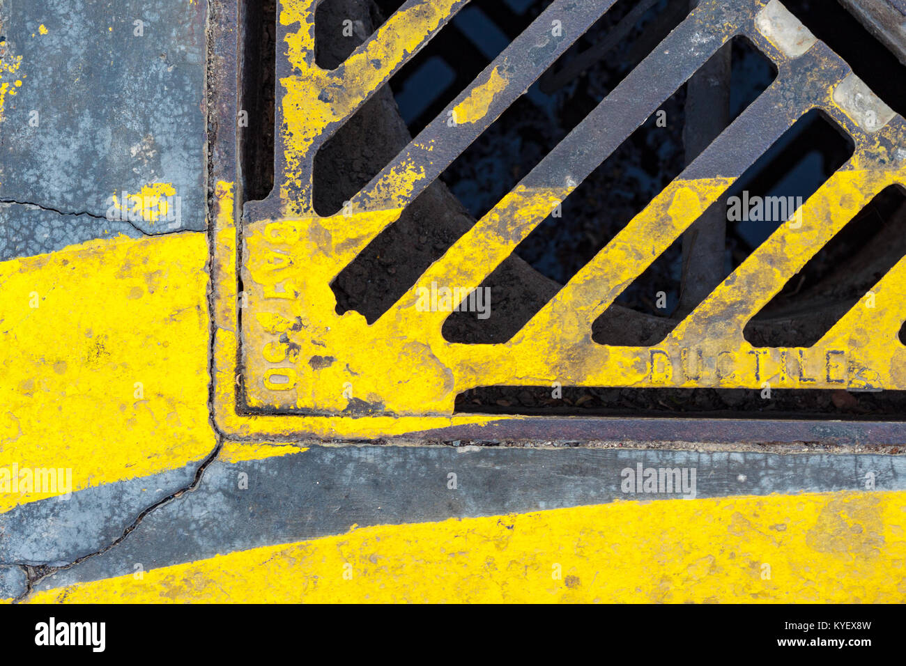 grey storm drain with bright yellow street lines over the top in Dubai ...