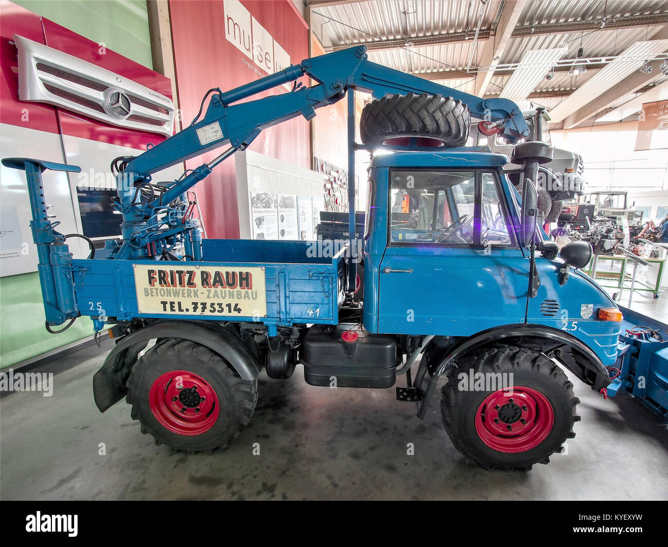 A photograph of a Unimog vehicle equipped with a snow plow, displayed ...