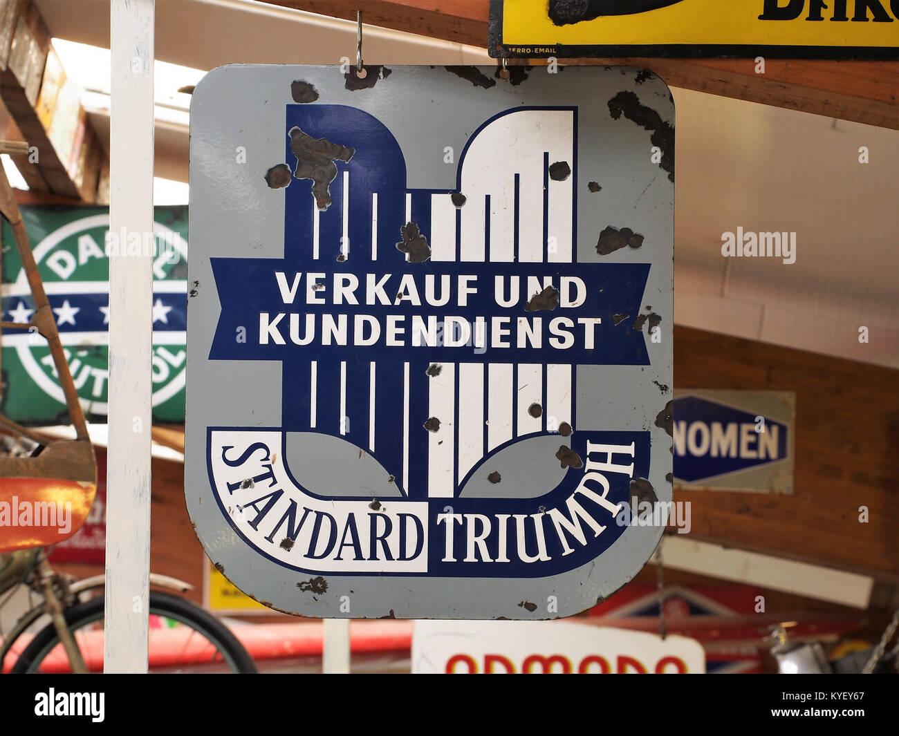 This image shows an enamel advertisement sign for Standard Triumph ...