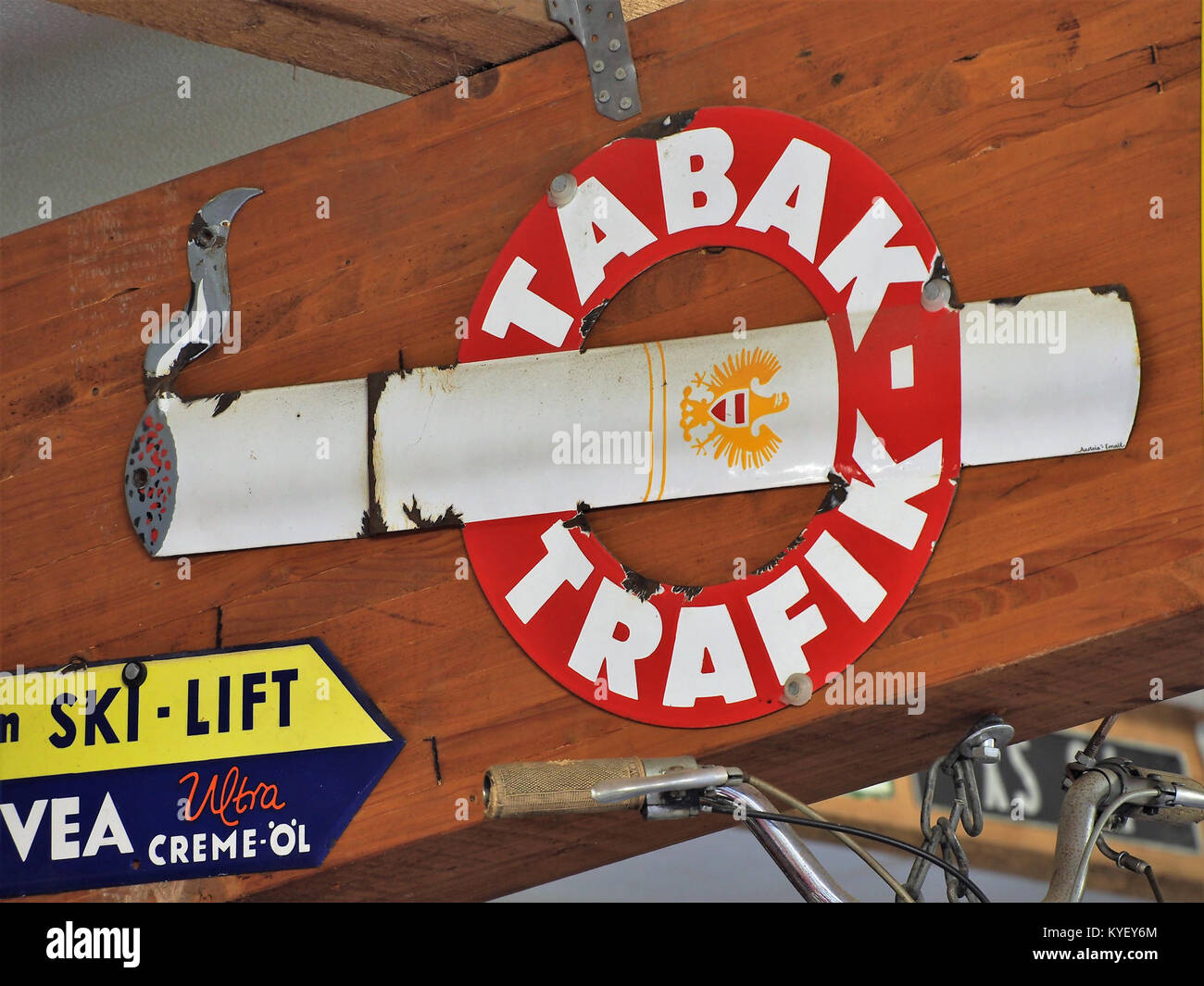 A photograph of an enamel advertisement sign for 'Tabak Trafik ...