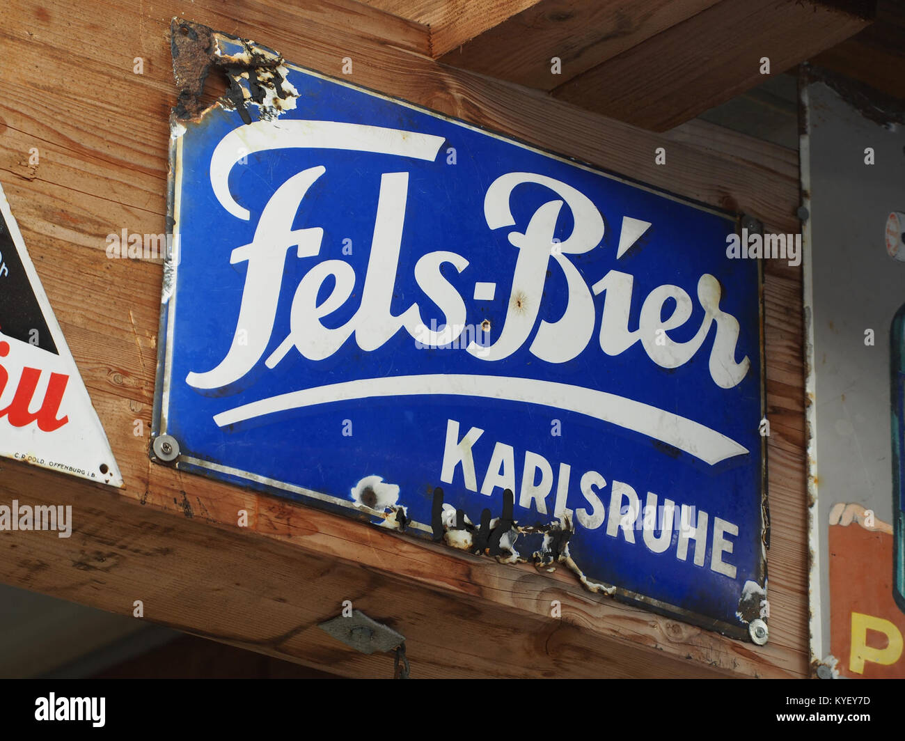A vintage enamel advertising sign for Fels-Bier Karlsruhe, displayed at ...