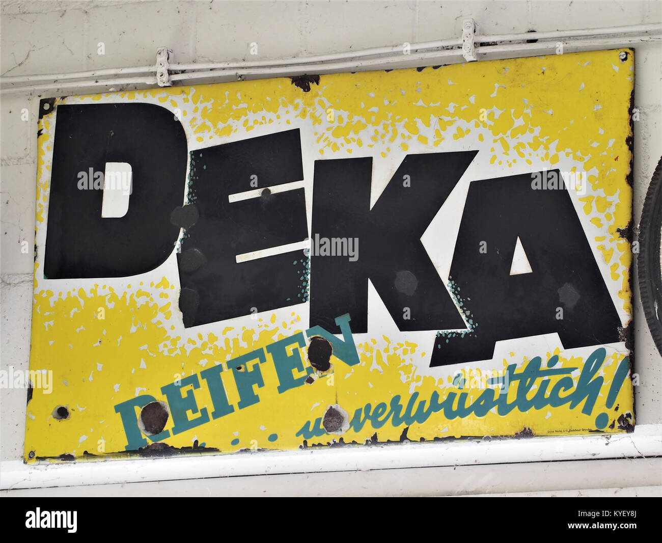 A photograph of the DEKA Reifen enamel advertising sign displayed at ...