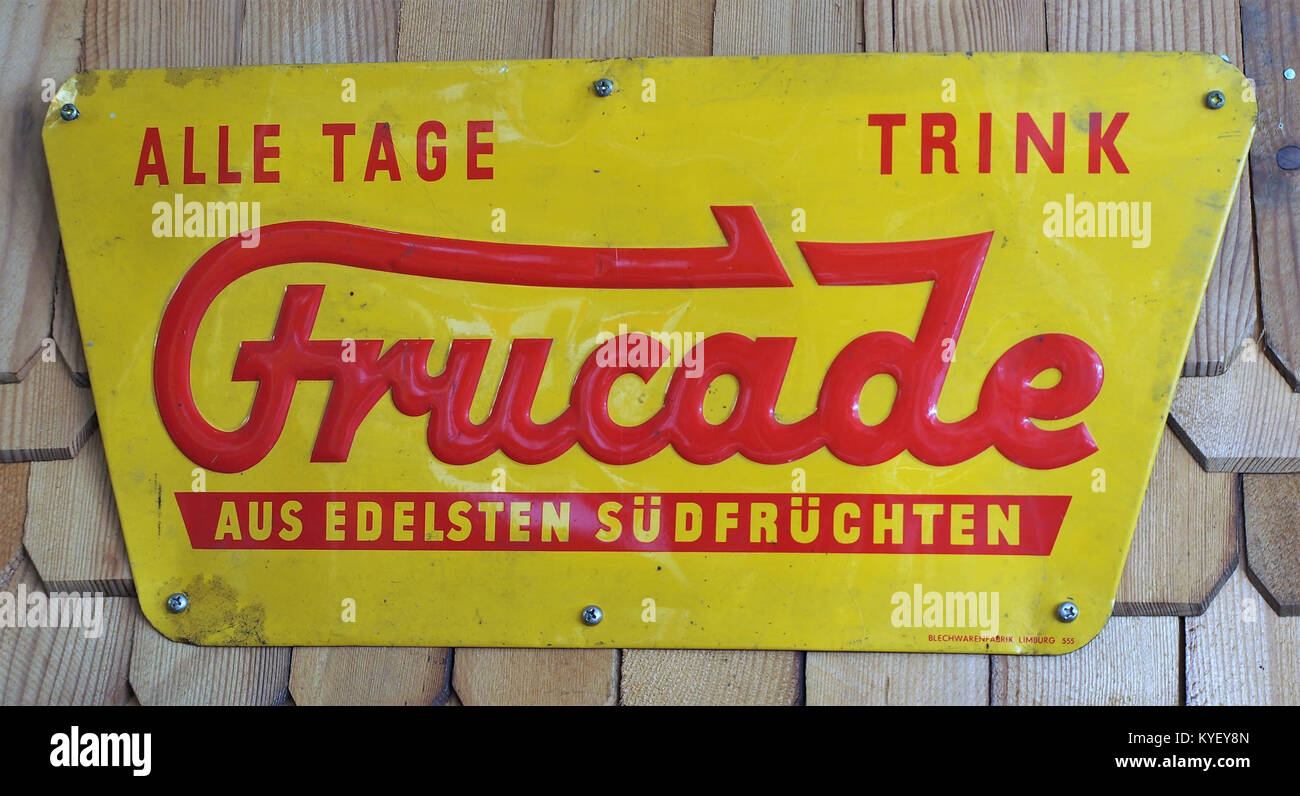 A vintage enamel advertisement sign for Frucade, displayed at the ...