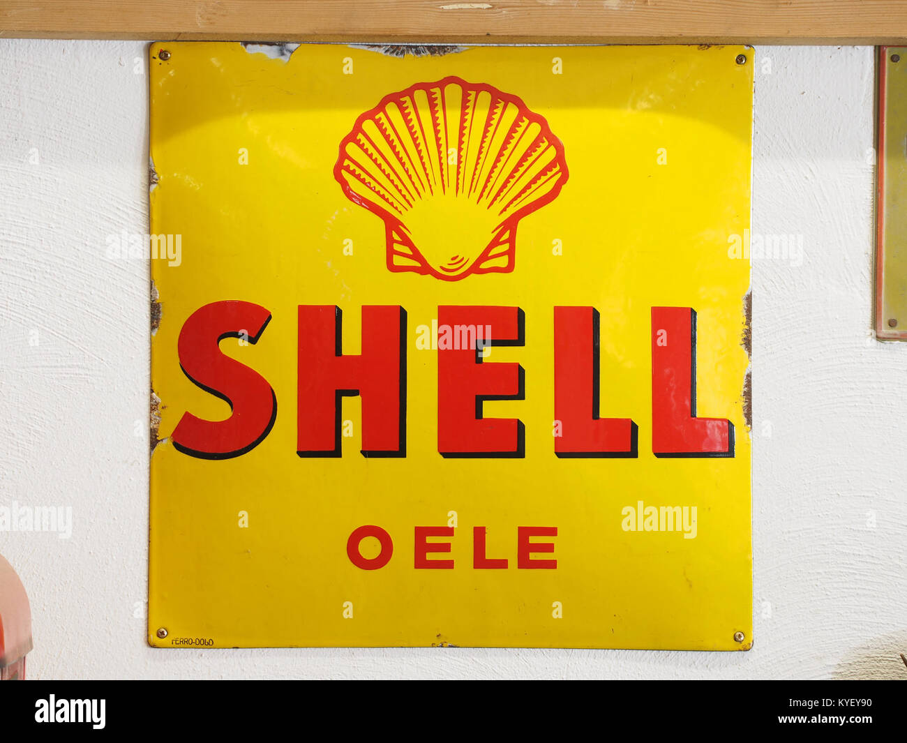 A vintage enamel advertisement sign for Shell Oele displayed at the ...