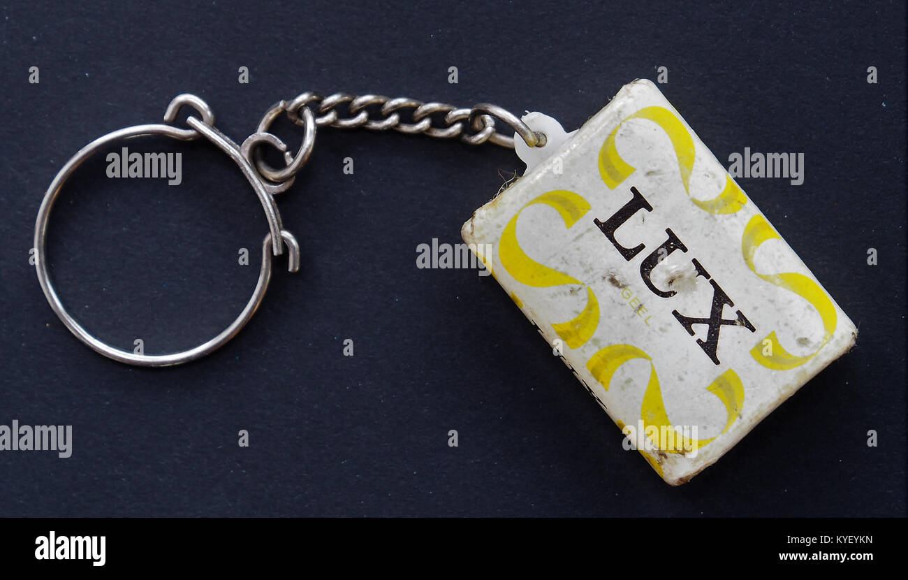 Photograph of a yellow Lux keychain, showcasing its design and branding ...