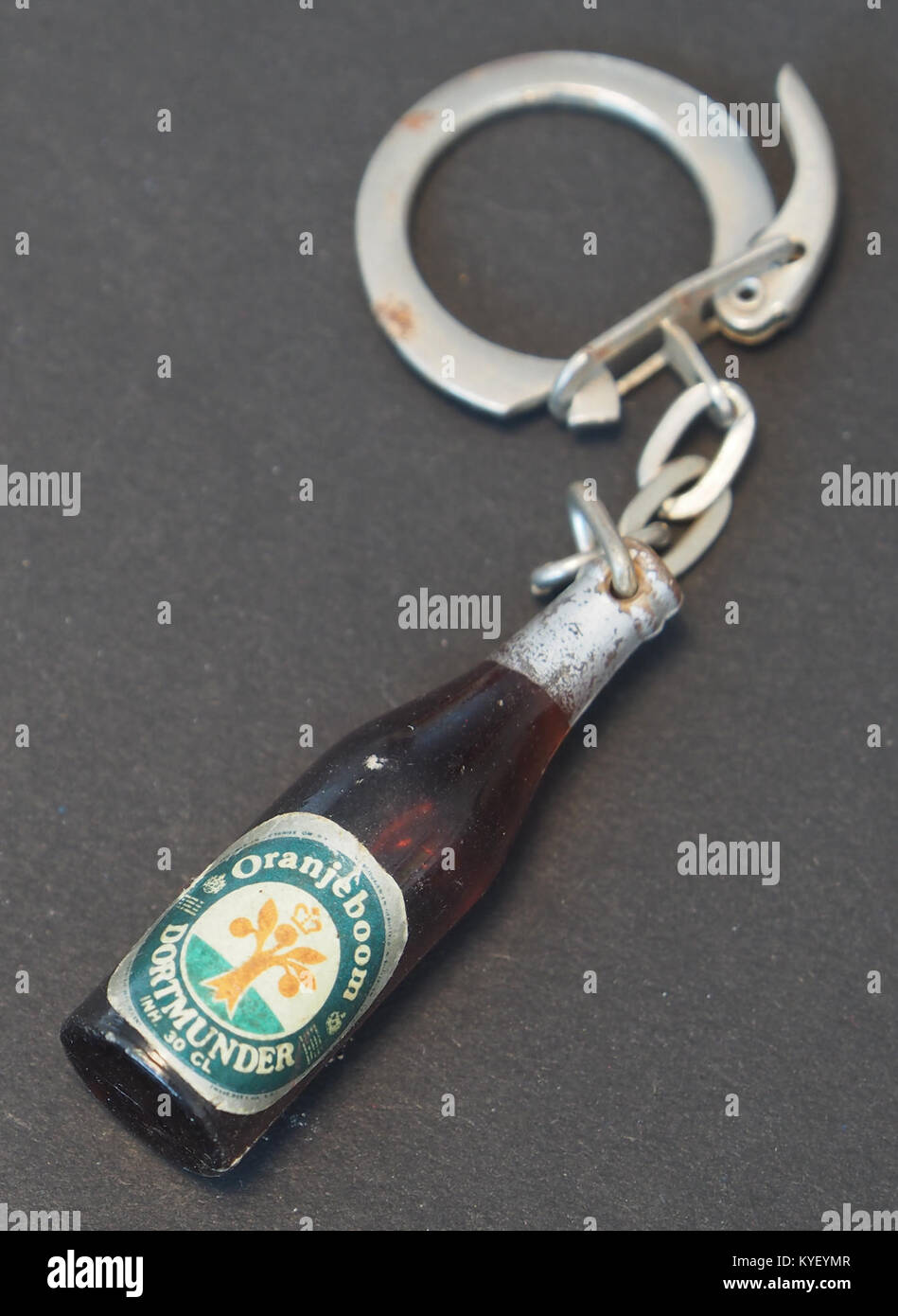 This image features a unique keychain designed as a miniature beer ...