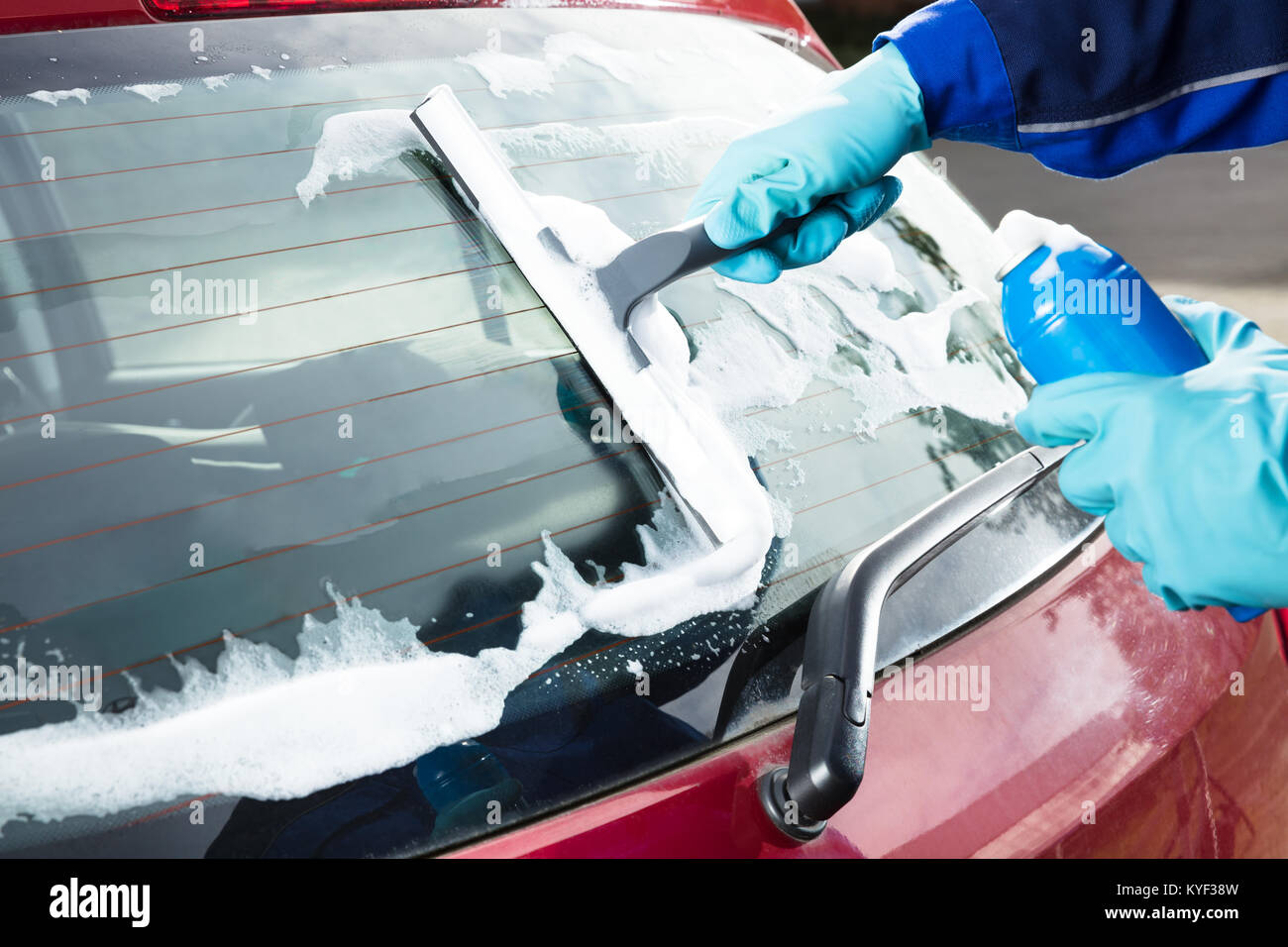 Close-up Of Person's Hand Washing Rear Windshield Of A Car Using ...