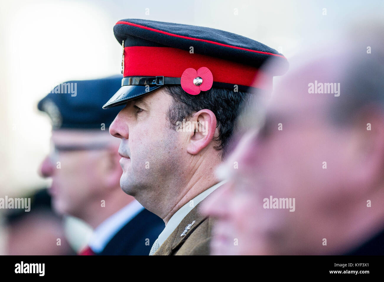 A man in uniform looks on with a poppy on his military uniform Stock ...