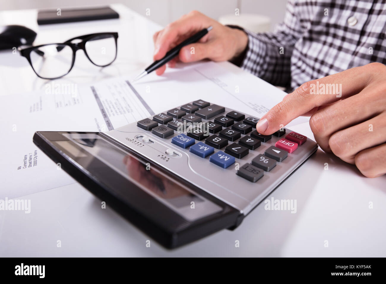 Close-up Of Businessman's Hands Calculating Invoice Using Calculator ...