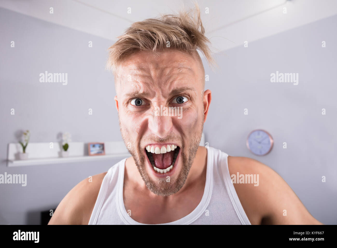 Portrait Of A Shouting Angry Young Man At Home Stock Photo - Alamy