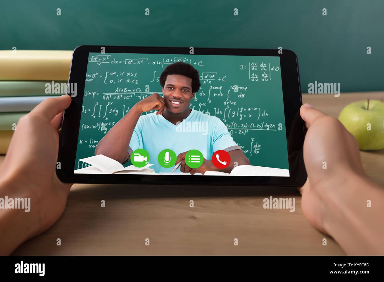 Close-up Of A Student's Hand Video Conferencing With Happy Male Teacher ...