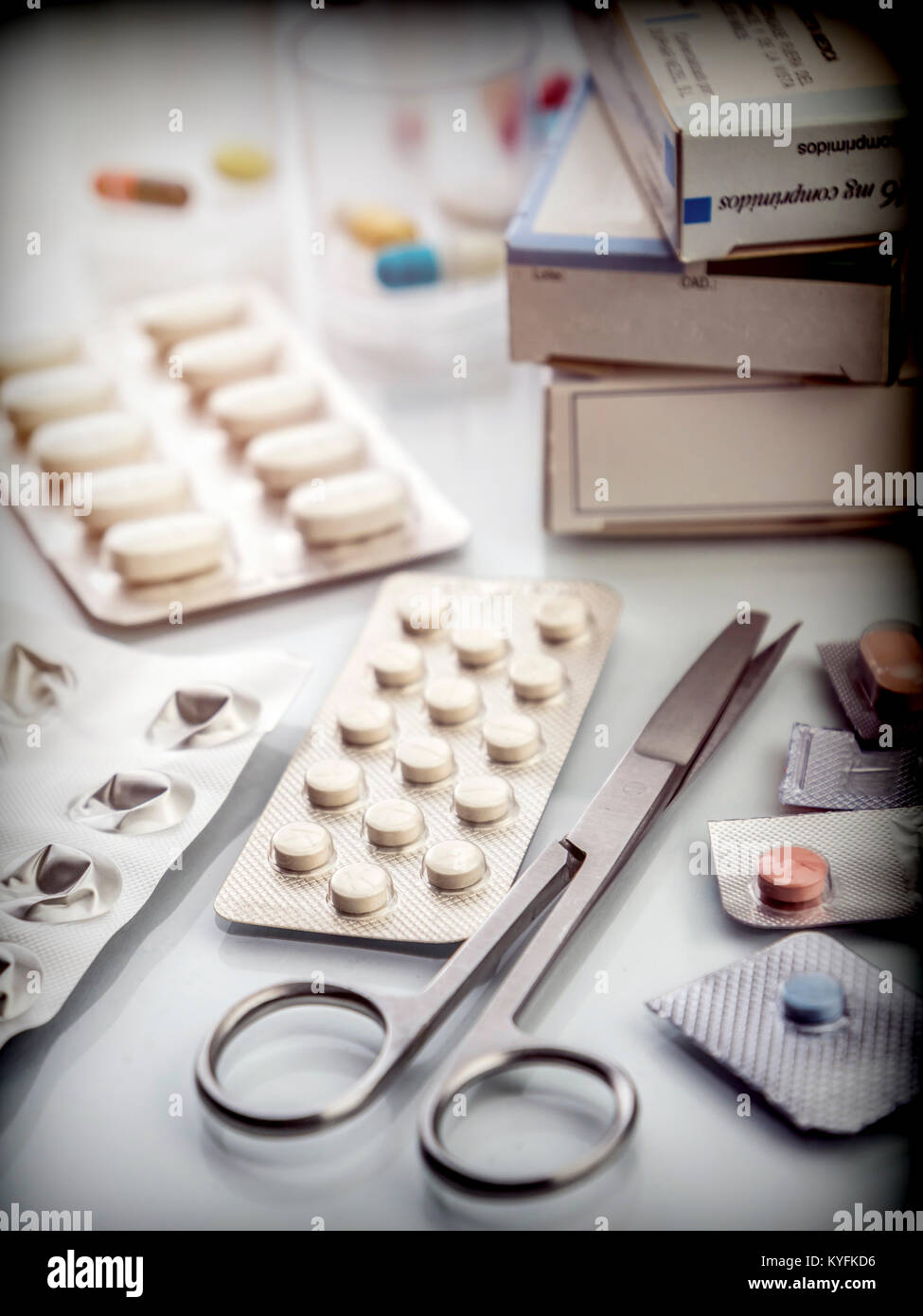 Scissors next to several blister cut, conceptual image Stock Photo - Alamy