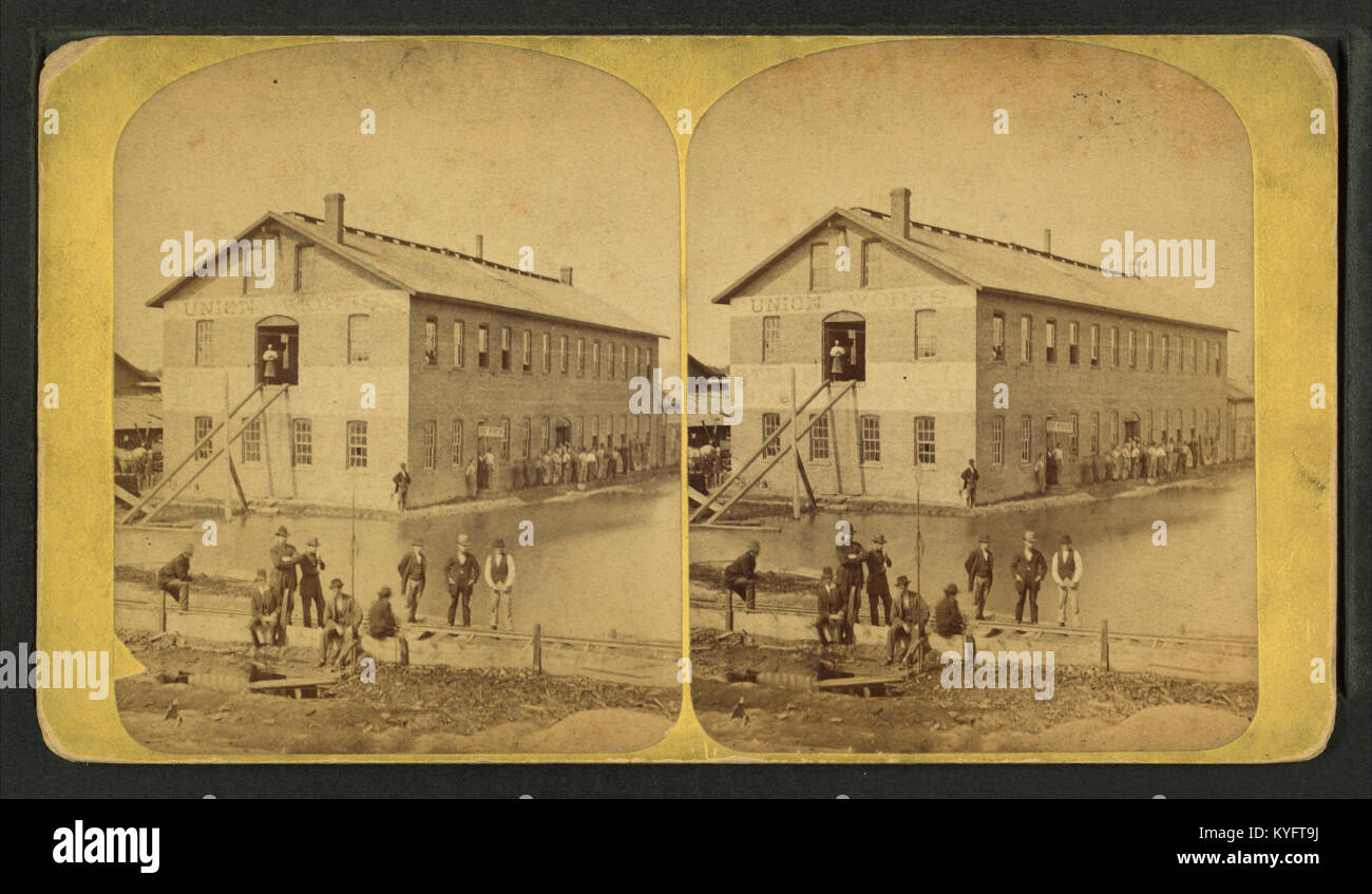 This photograph depicts workers standing at the entrance of Union Works ...