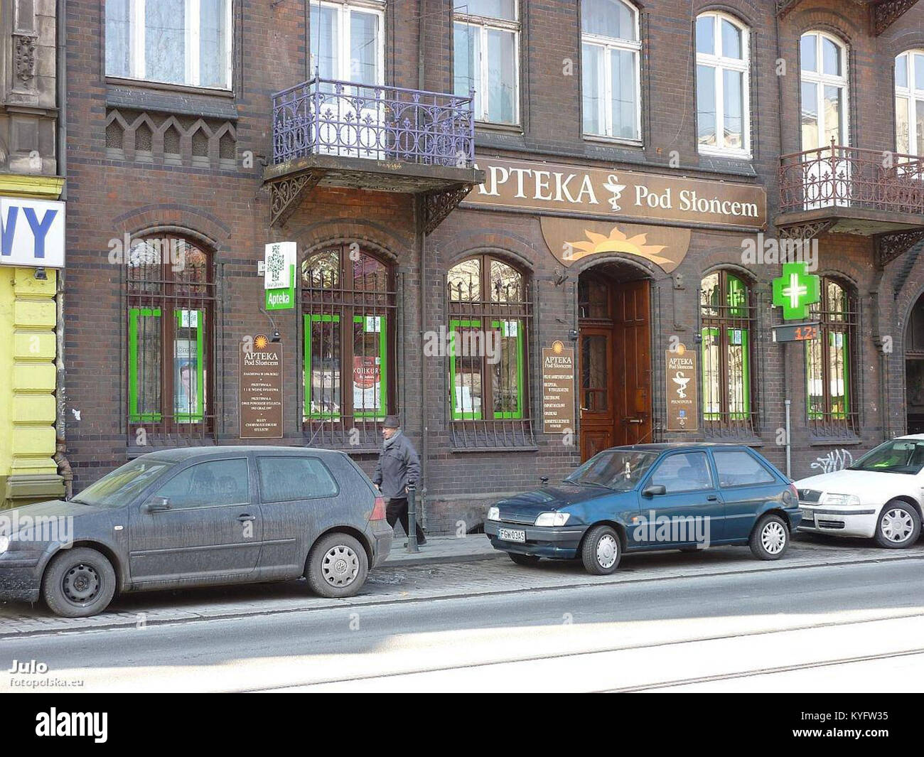This photograph captures the historic Apteka Pod Sloncem pharmacy at ...