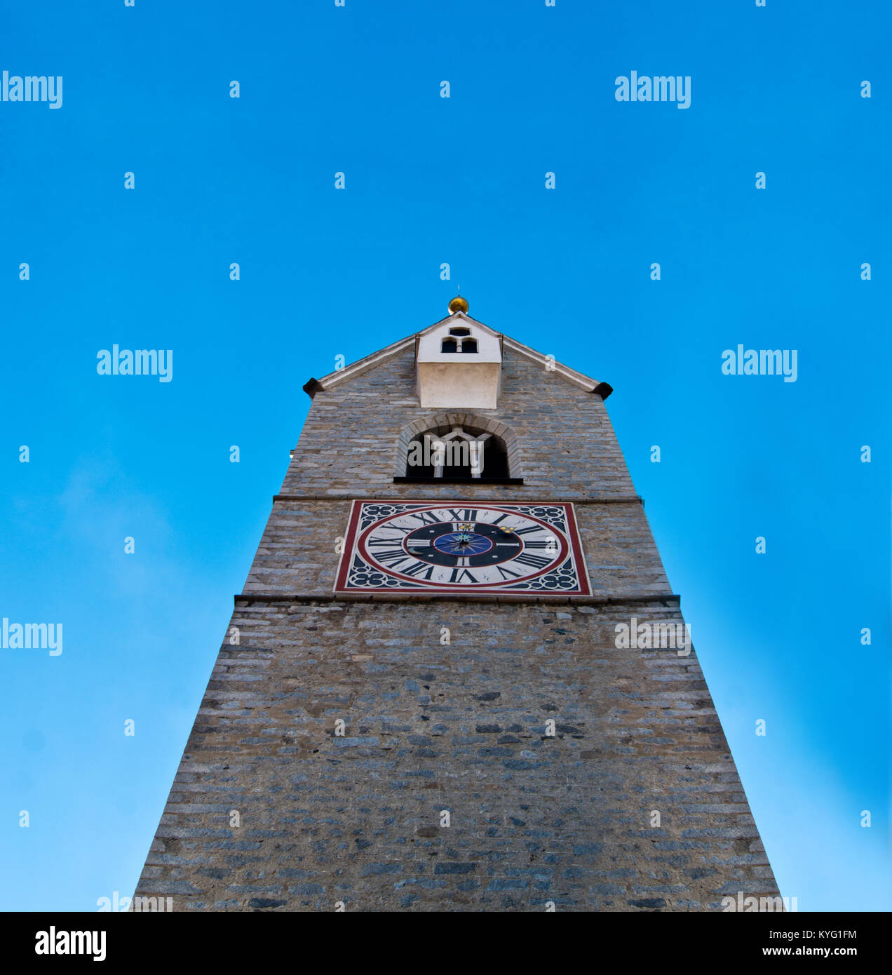 typical bell tower with clock of the churches of the mountains of ...