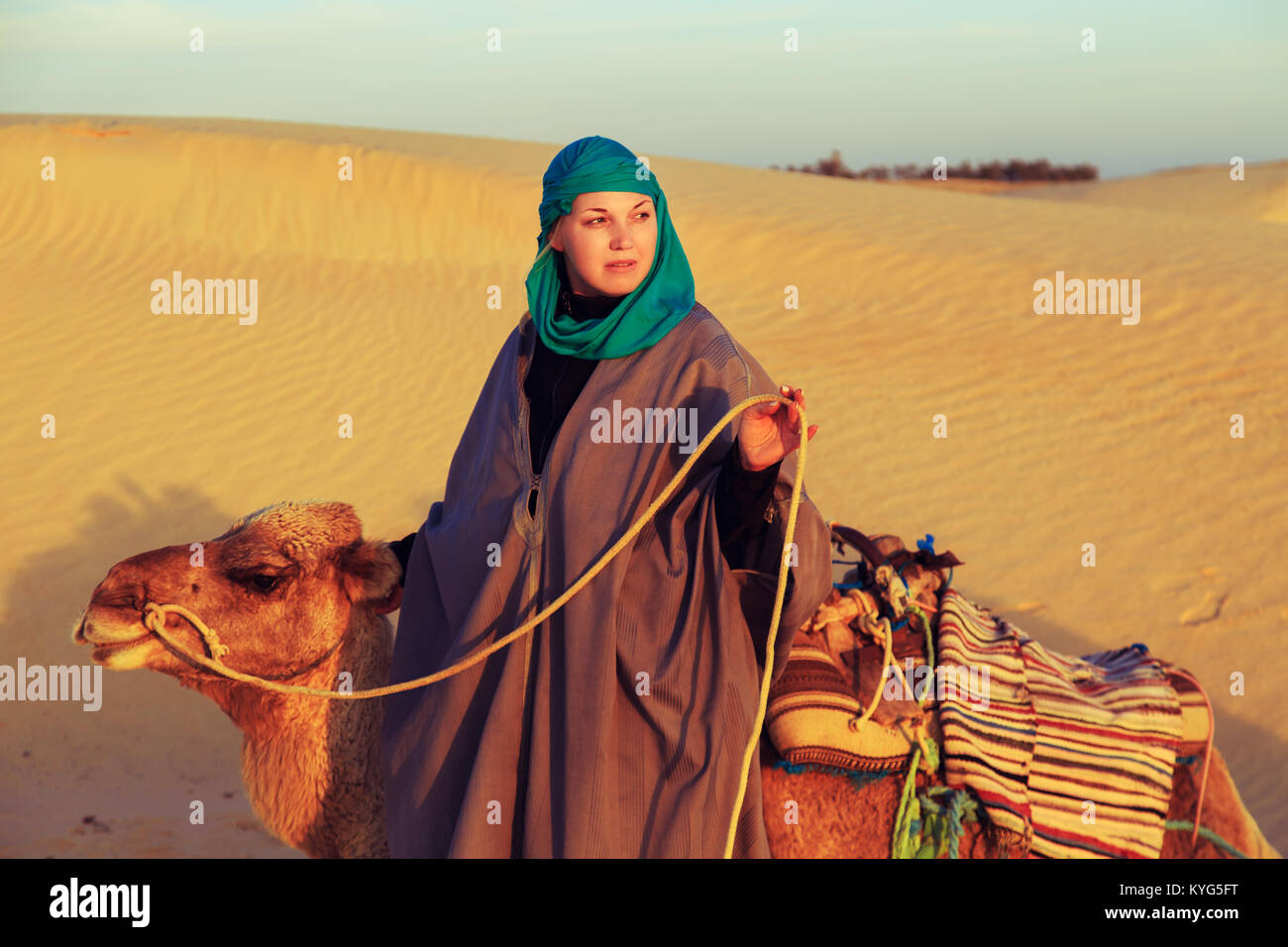 Woman in Bedouin dress with a camel in the Sahara desert, Tunisia ...