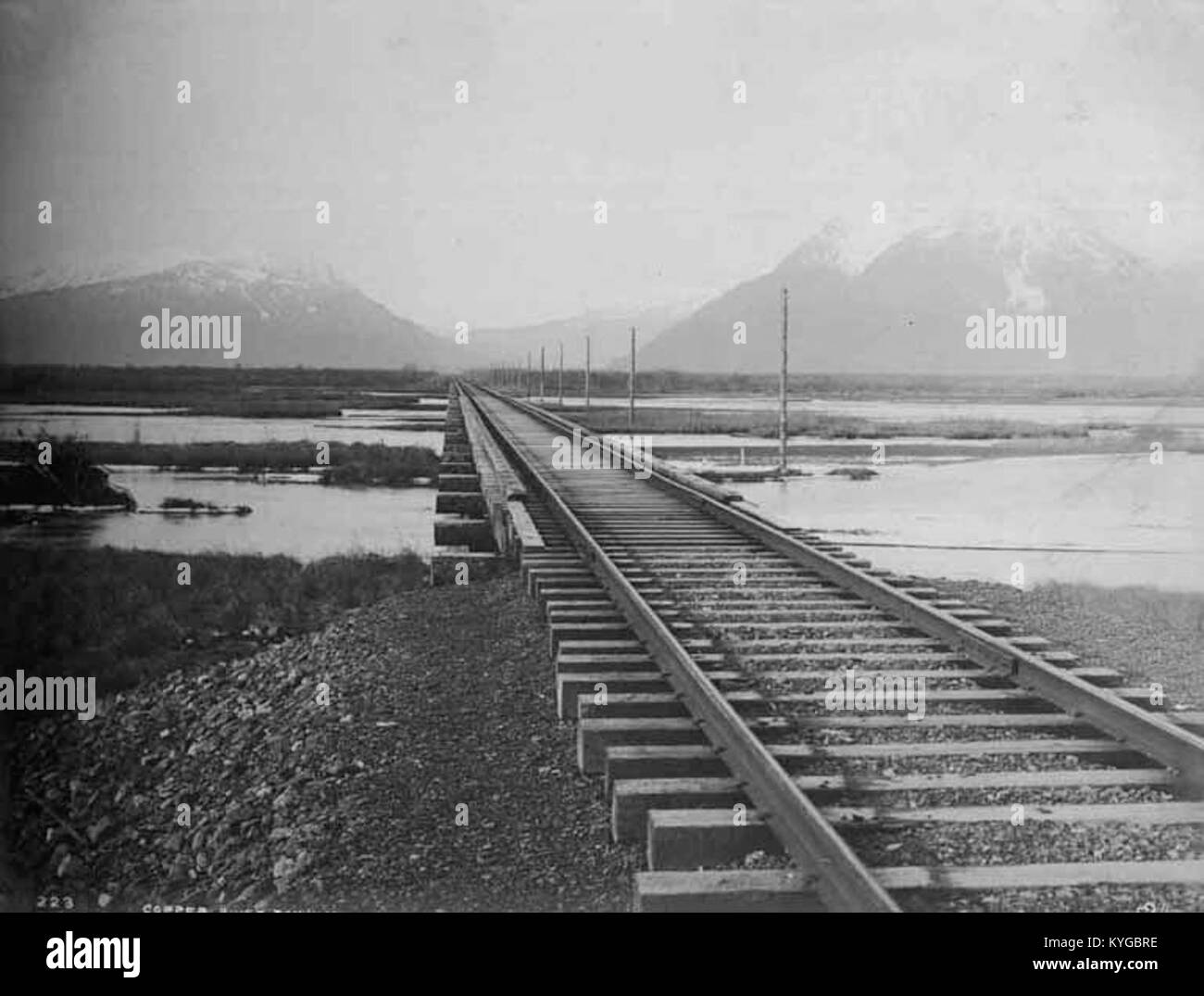 A photograph taken in 1908 showing railroad tracks crossing flat land ...
