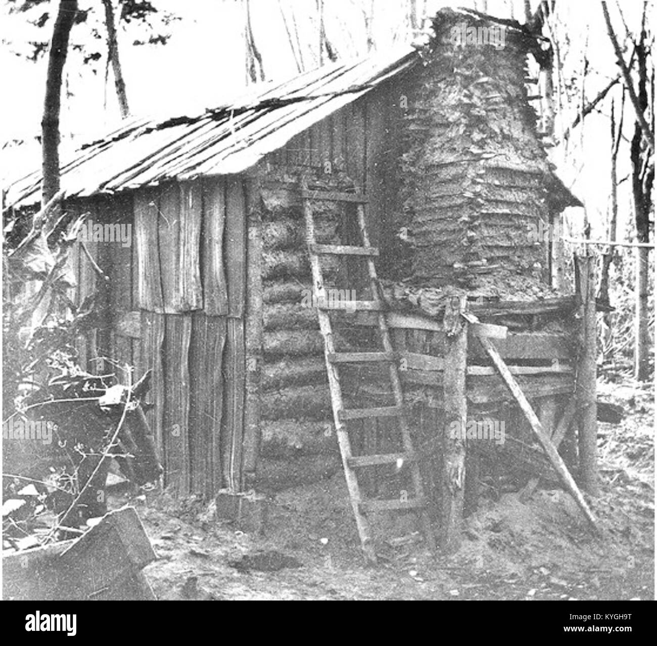 A photograph dated March 26, 1899, showing a rough cabin near Fort ...