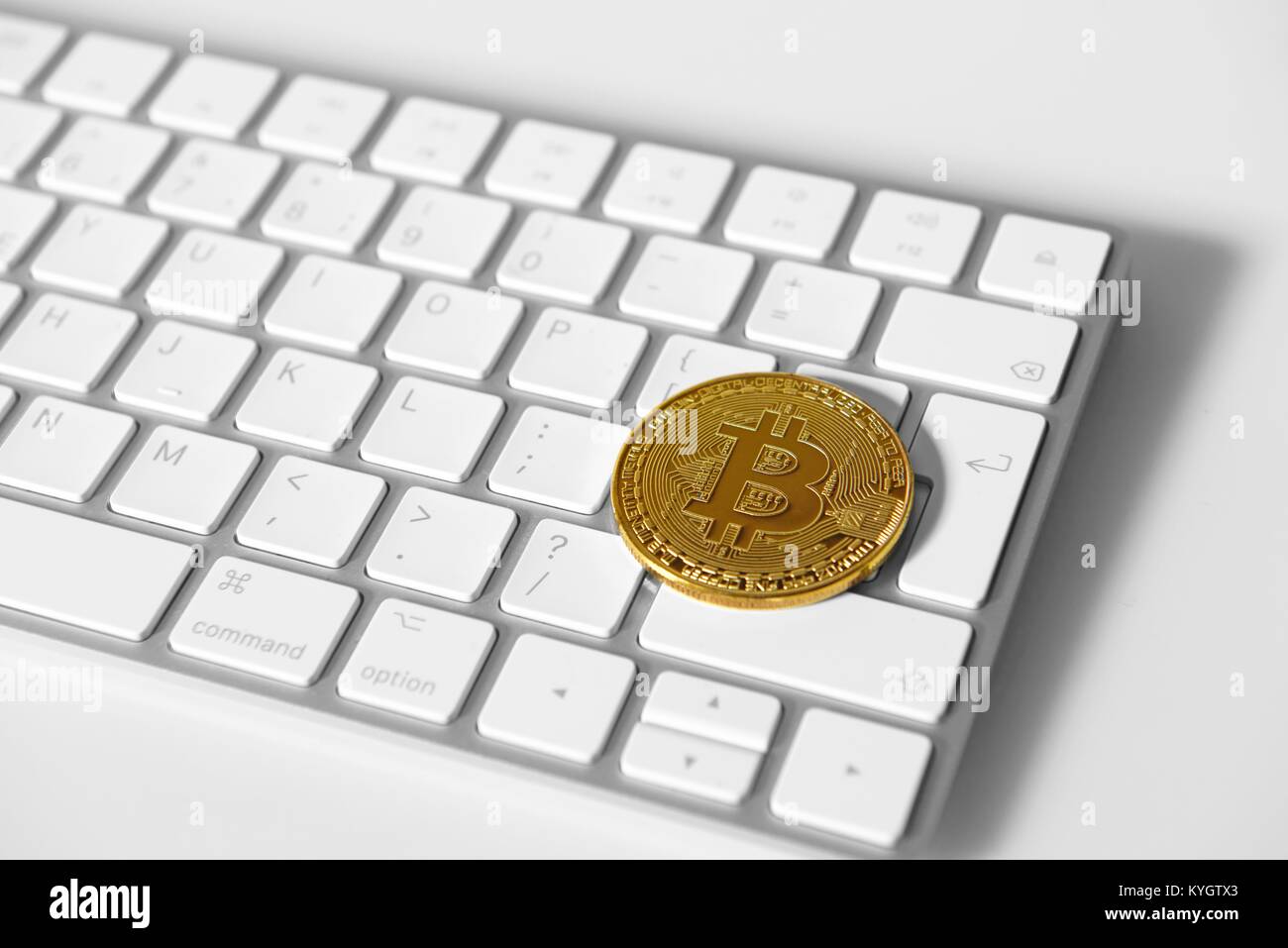Bitcoin gold coin on white keyboard Stock Photo - Alamy