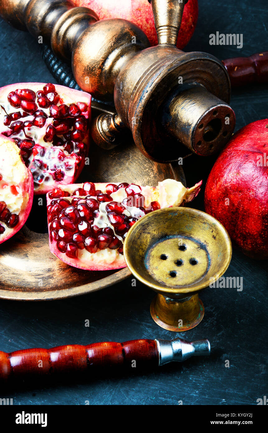 Exotic smoking shisha in east style with tobacco aroma of pomegranate ...