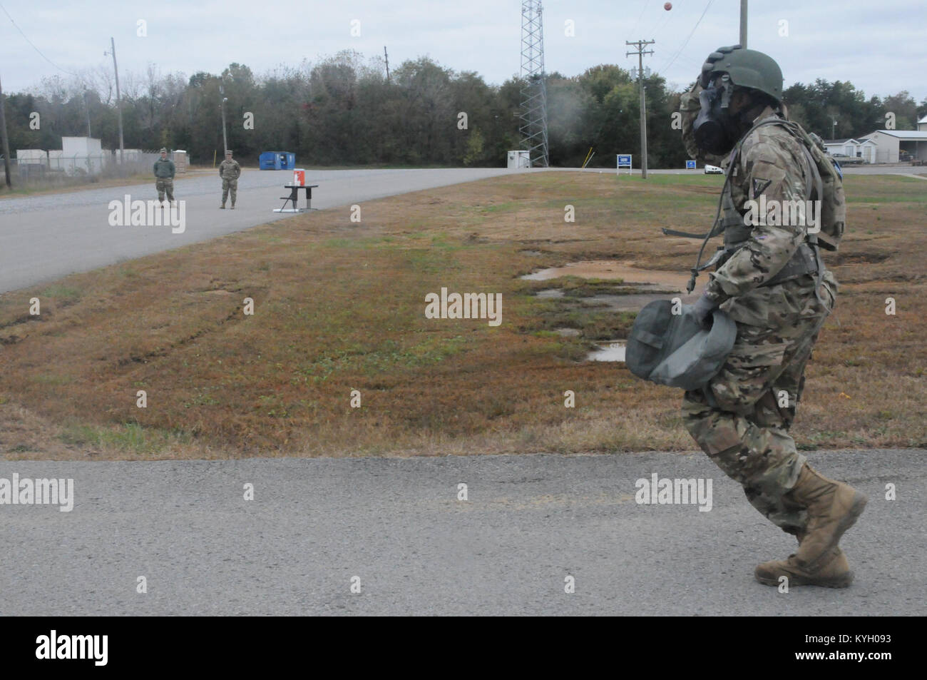 Soldiers don gas masks as they participate in the combat run portion of ...