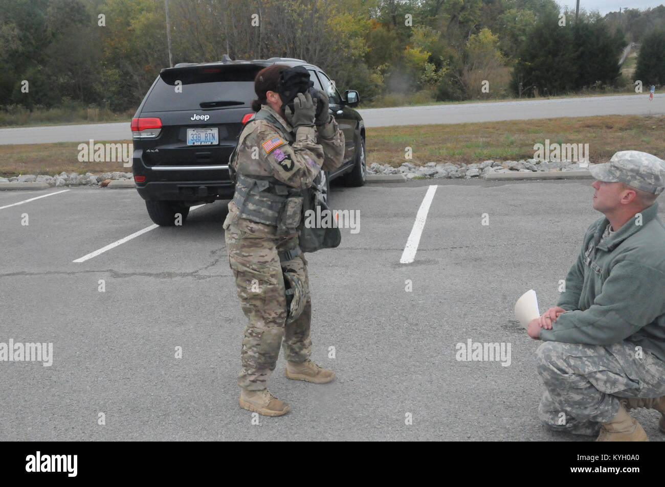 Soldiers don gas masks as they participate in the combat run portion of ...