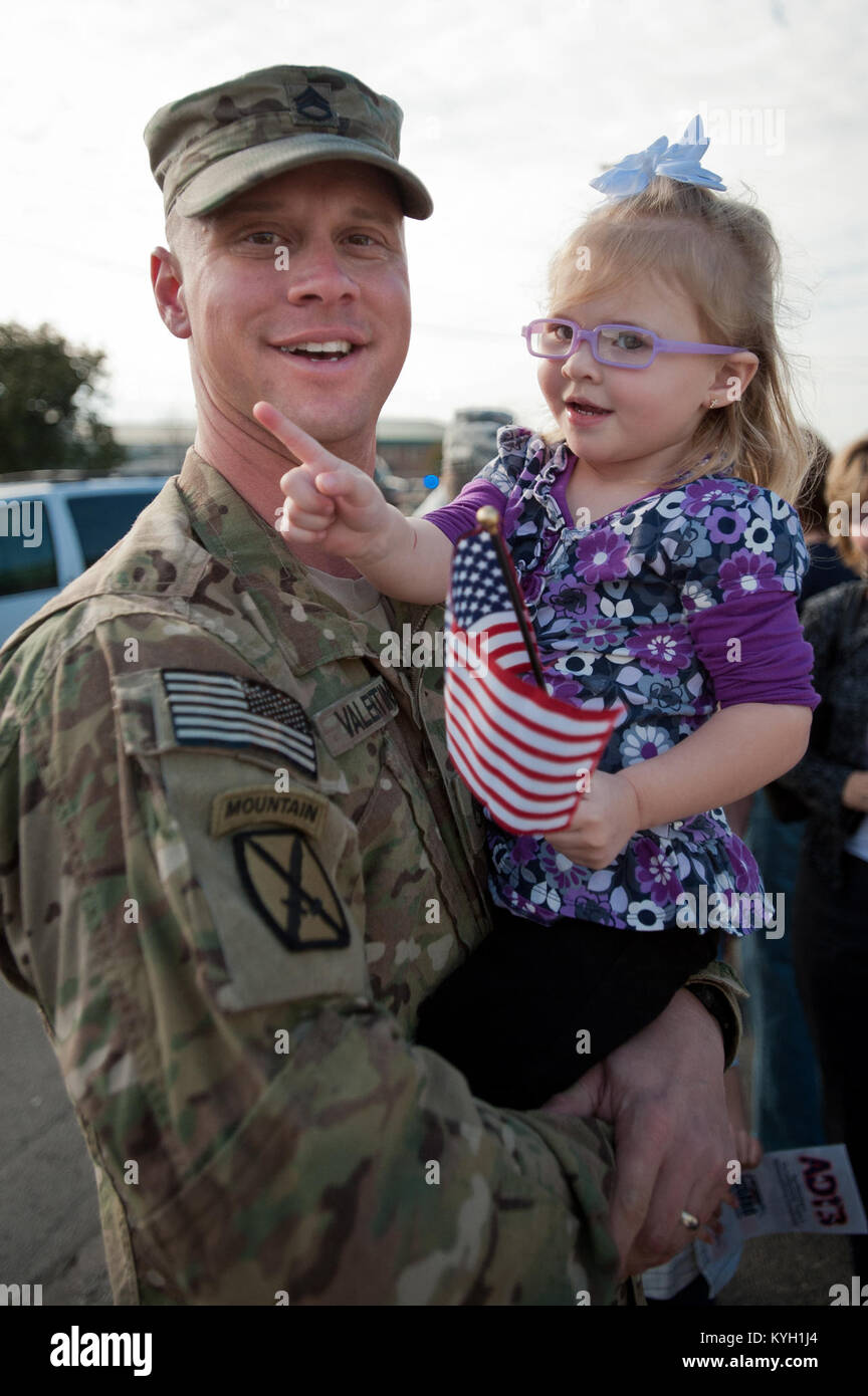 Staff Sgt. Jeff Valentine holds his daughter, Taylor, for the first ...