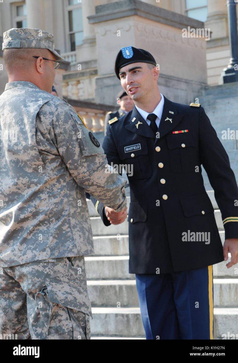 Staff Sgt. John Riggi shakes hands with newly promoted 2nd. Lt. Joshua ...