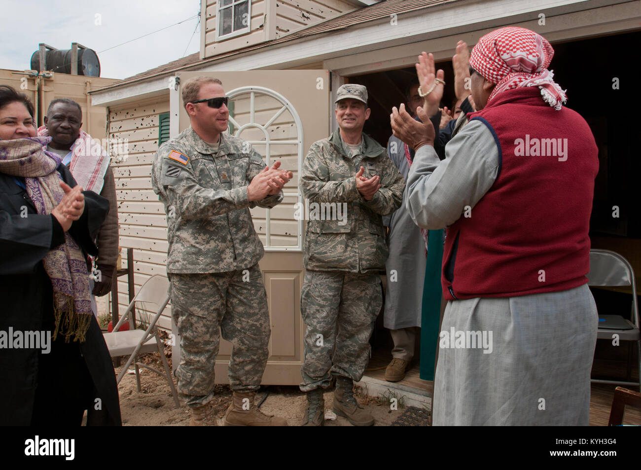Role-playing actors give Col. Warren Hurst (center), commander of the ...