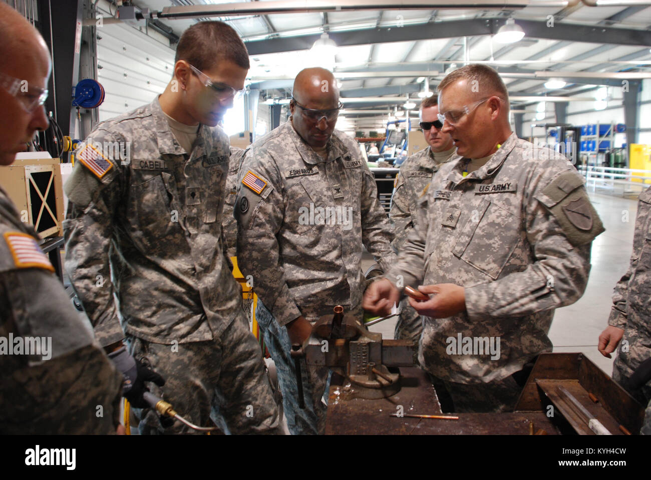 Col. John Edwards Jr is given a briefing about soldering copper by Sgt ...