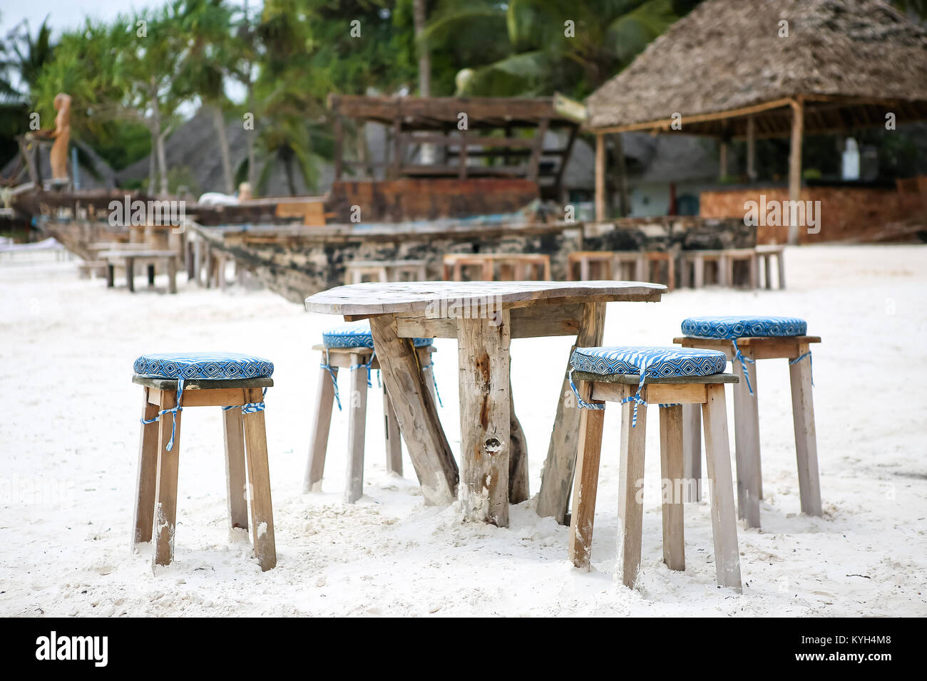 Wooden table and chairs on the beach. Furniture for lounging on Stock ...