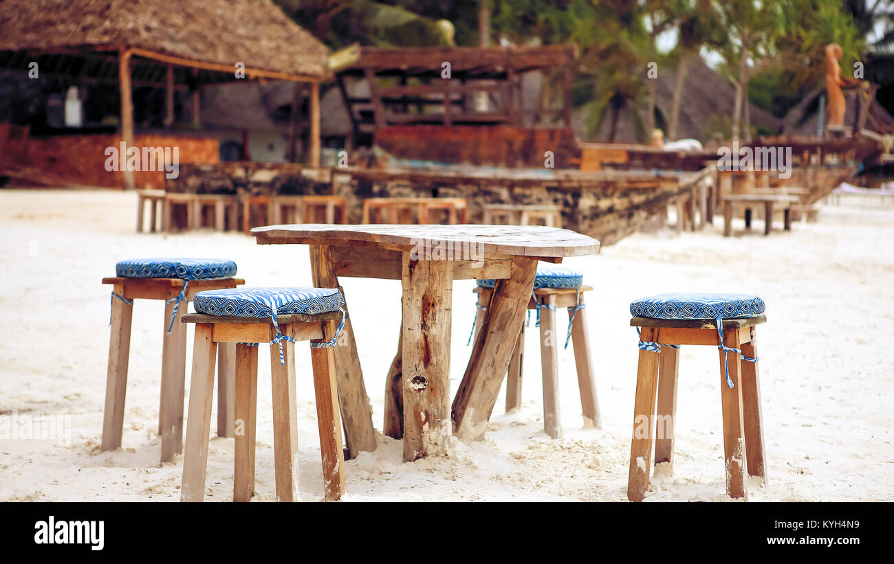 Wooden table and chairs on the beach. Furniture for lounging on Stock ...