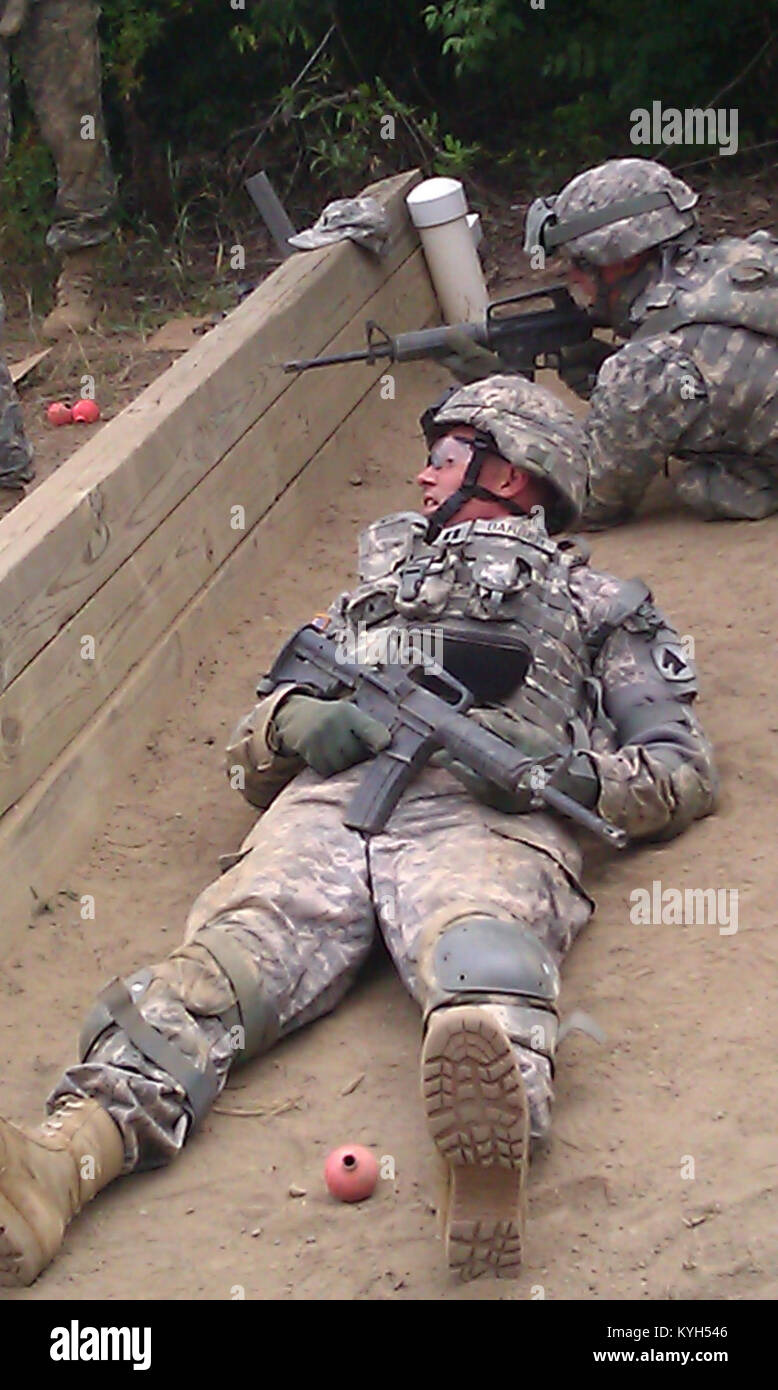 Capt. Vincent Barber, Commander HHB 2/138th FA, prepares to throw a ...