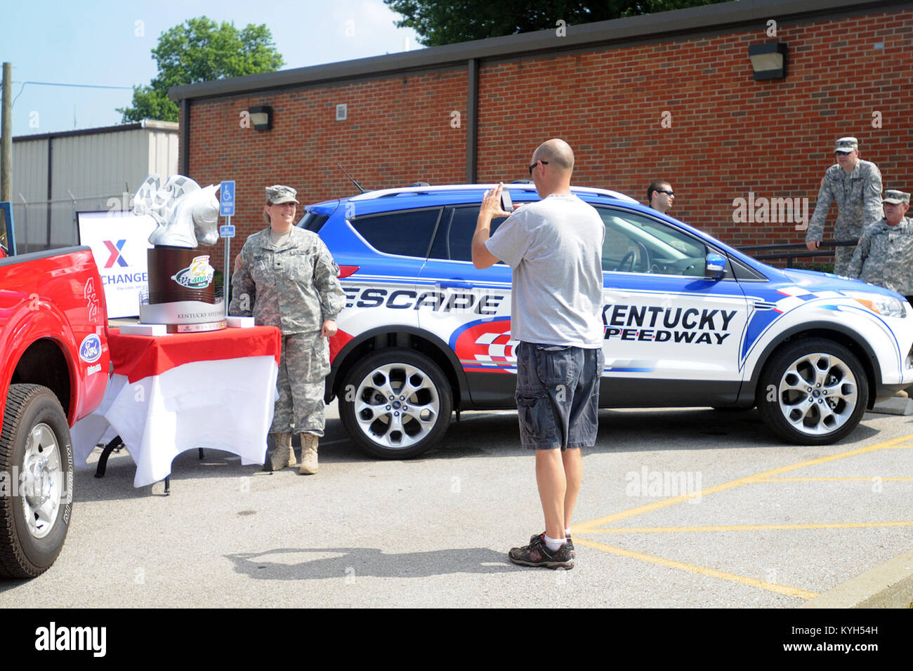 Shannon Riddle takes a photo of his wife, Spc. Christina Riddle, both ...