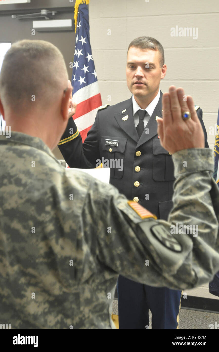 Col David Graetz gives an oath to newly promoted Capt. Mark Slaughter ...