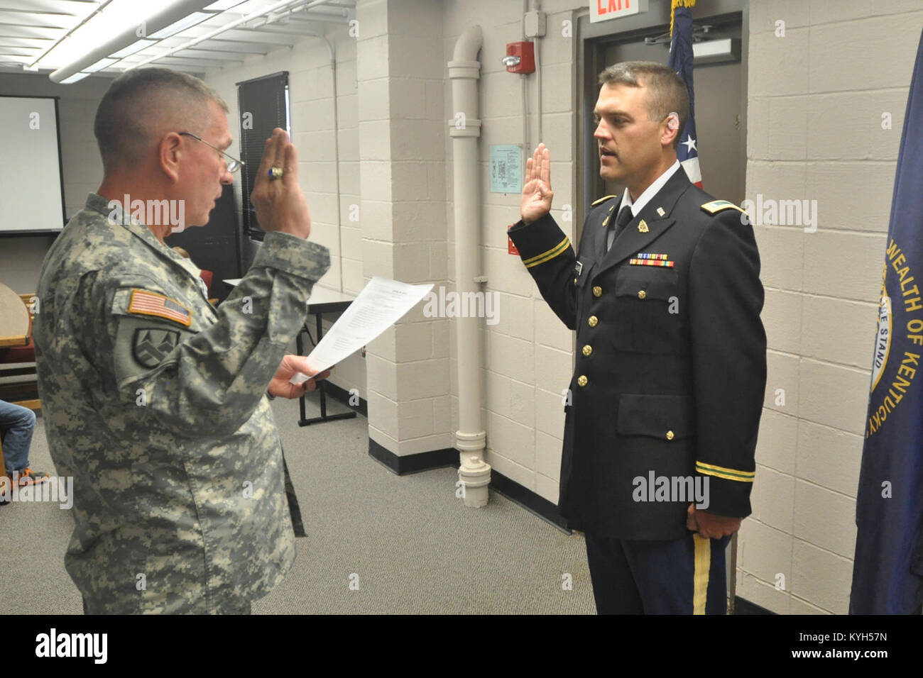 Col David Graetz gives an oath to newly promoted Capt. Mark Slaughter ...