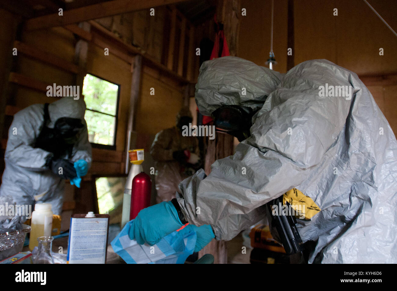 Members of the 41st Civil Support Team investigate a cabin where ...