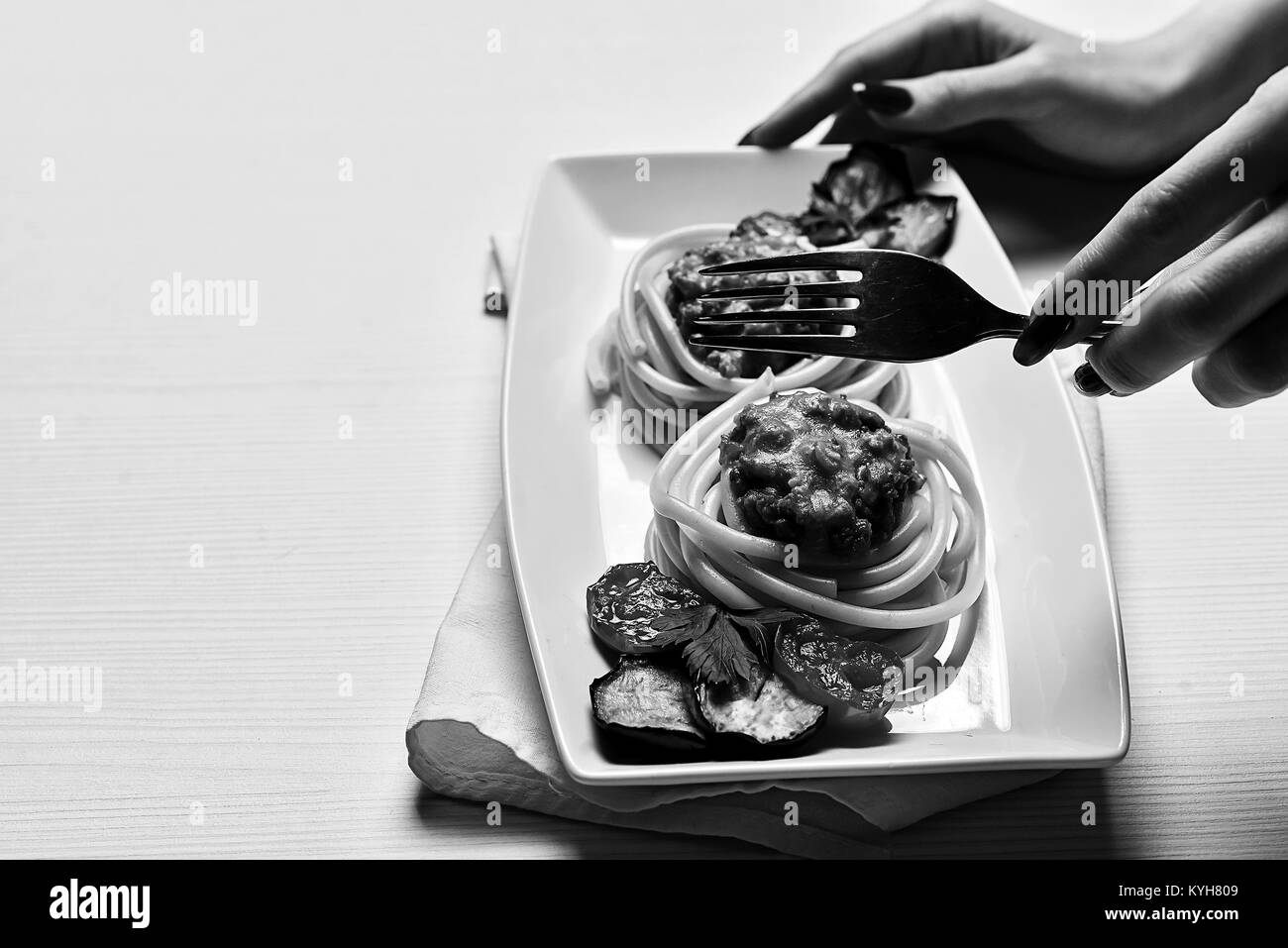 Dinner in the restaurant. Hands plates of food. Fork for eating Stock ...