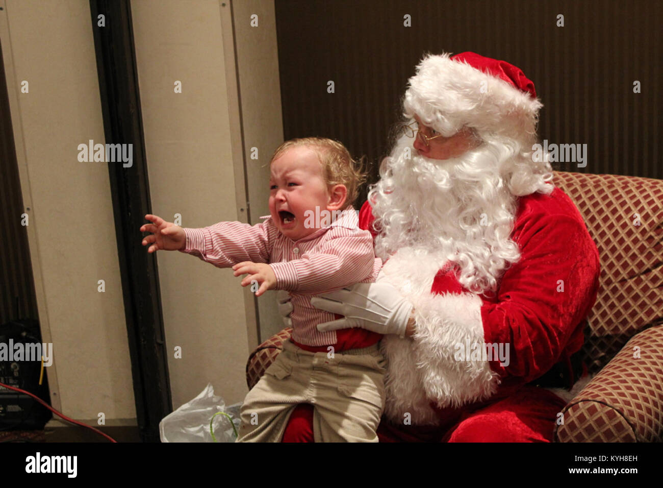 Father Chrismas with crying child Stock Photo - Alamy