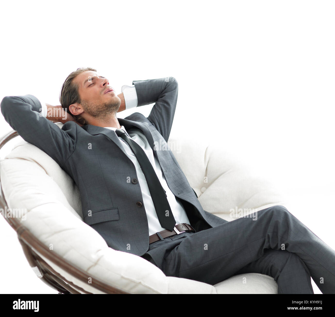 young businessman meditating in big comfortable armchair Stock Photo ...