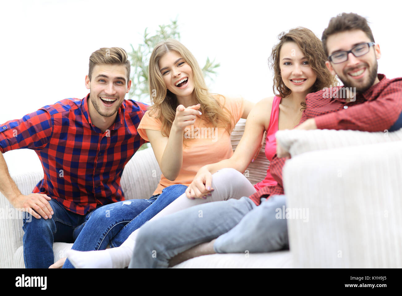 group of happy young people sitting on the couch Stock Photo - Alamy