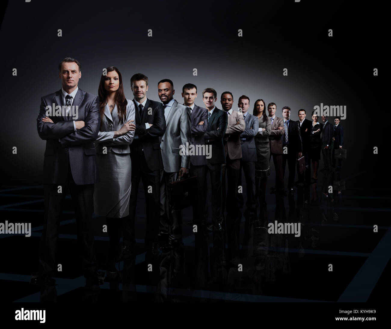 business team formed of young businessmen standing over a dark ...