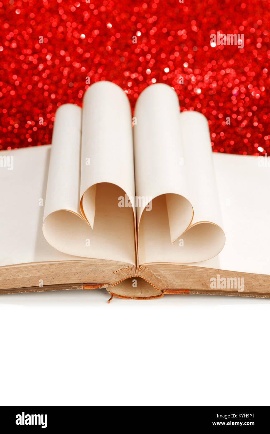 Pages of open book rolled in heart shape on glitter background Stock ...