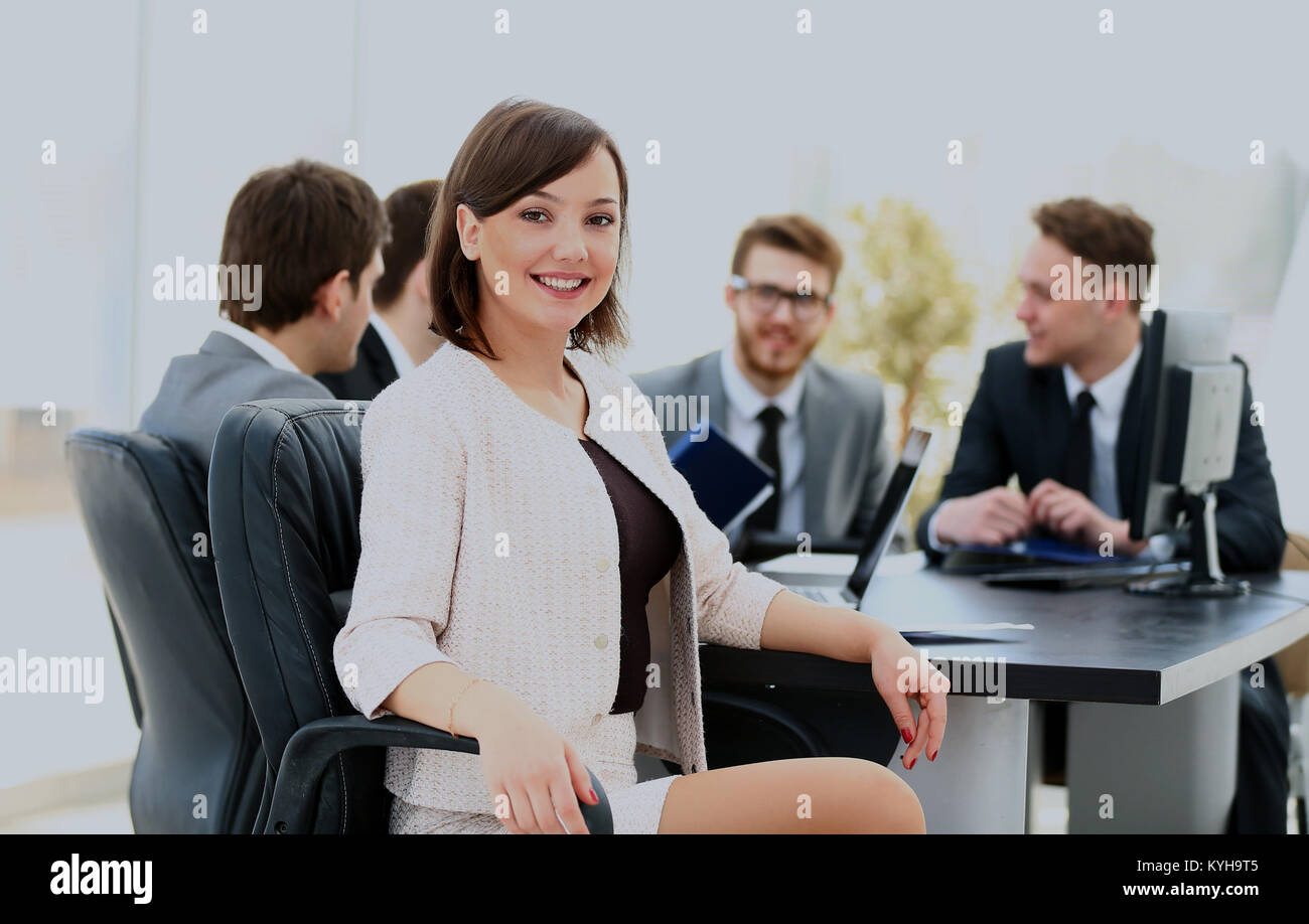 Portrait of a charismatic woman at a meeting while her team working in ...