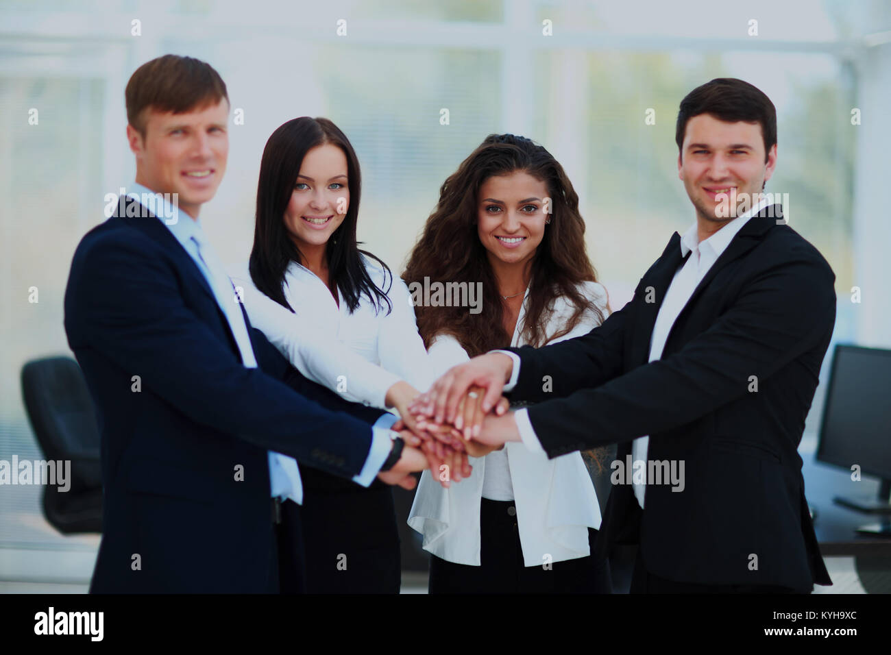 Group of business people piling up their hands together Stock Photo - Alamy
