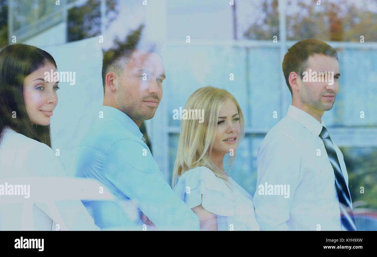 Happy smiling business team looking through window Stock Photo - Alamy
